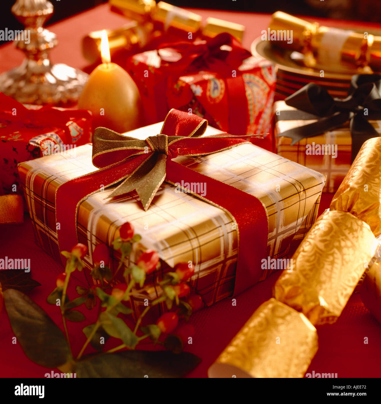 A close up view of a wrapped present on a Christmas table surrounded by ...