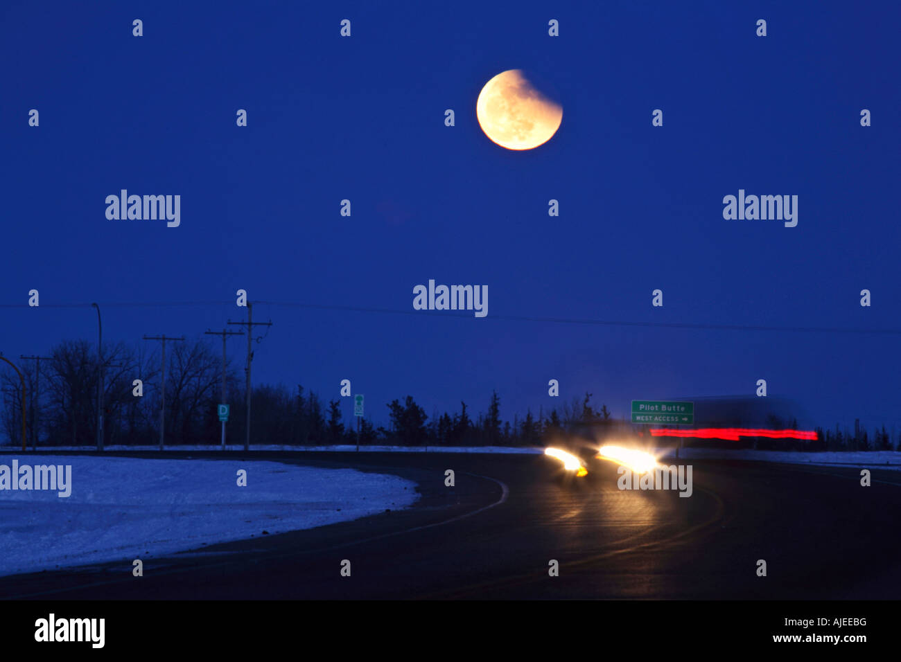 Partial moon eclipse and car lights Stock Photo - Alamy