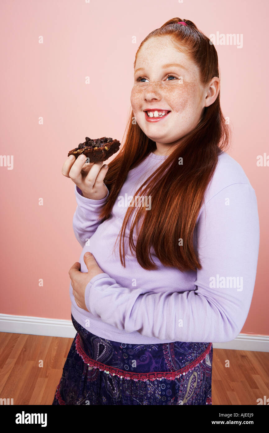 Overweight Girl 13 15 Smiling Holding Brownie Hand On Belly Stock