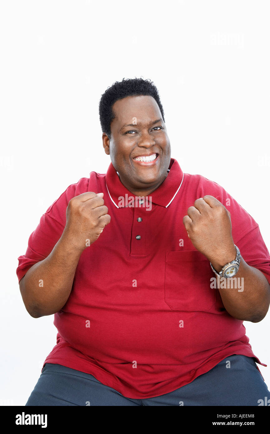 Overweight Man sitting arms raised, smiling, portrait Stock Photo - Alamy