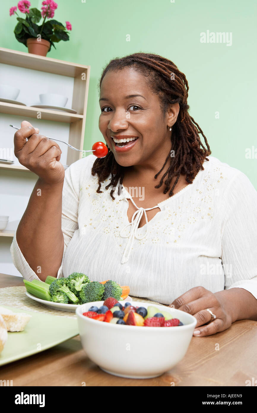Overweight woman eating healthy food, portrait Stock Photo - Alamy