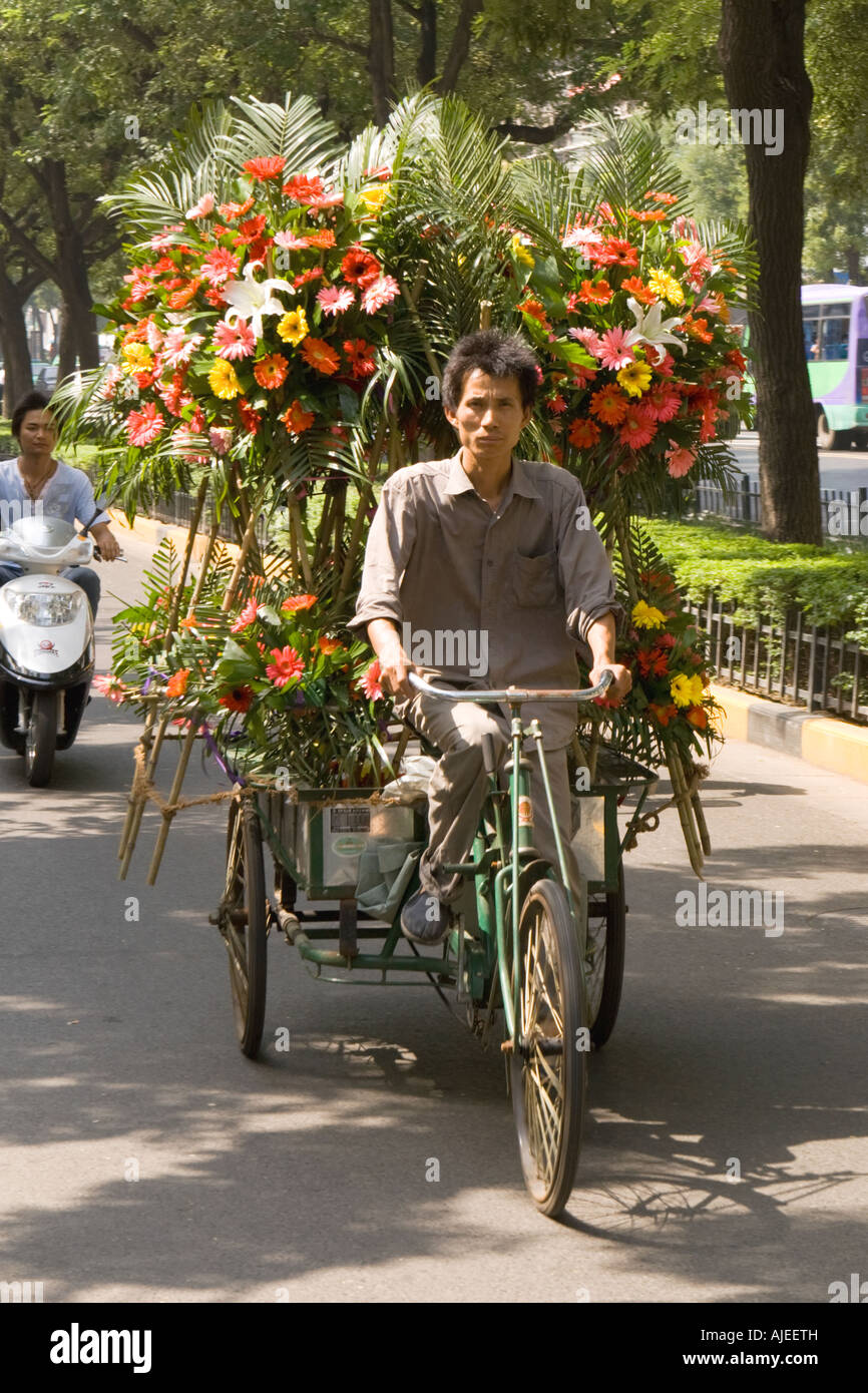 Mobile flower seller on bicycle / tricycle in city of Xian, China Stock ...
