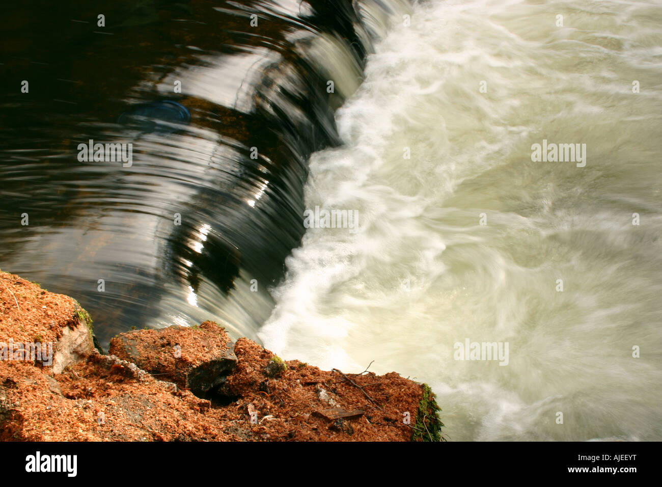 A small waterfall in a stream in Derbyshire, England as water flows ...
