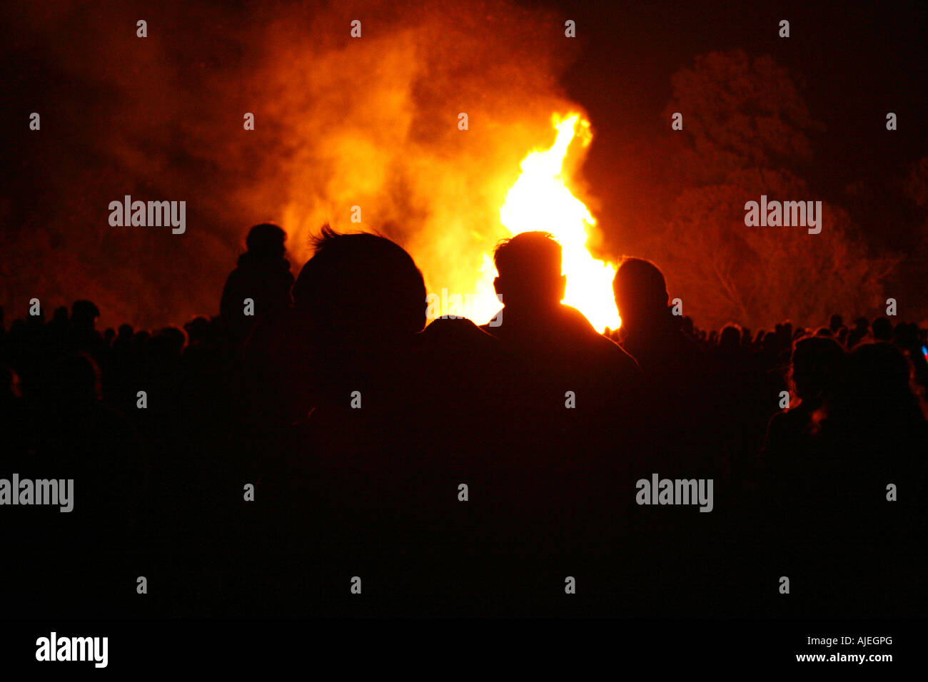 Crowd of people against smoke and flame of large bonfire Stock Photo ...