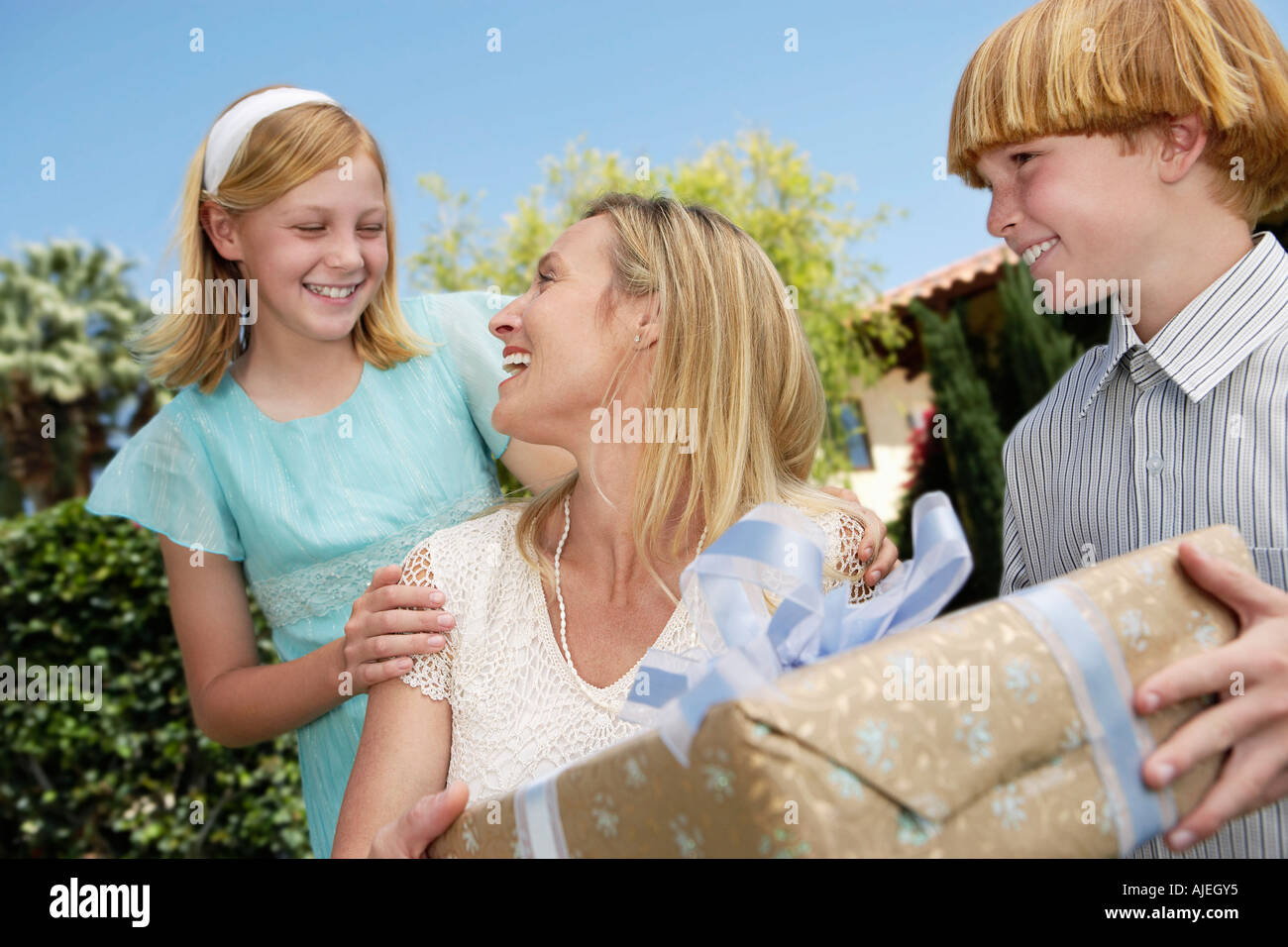 Gift hand over siblings hi-res stock photography and images - Alamy