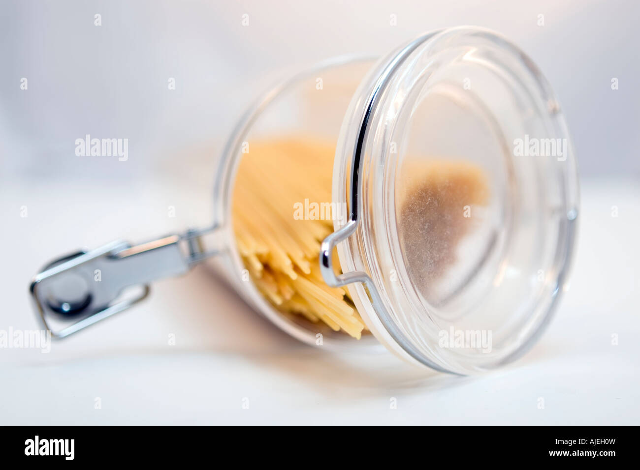 Spaghetti in a container on a cool blue background Stock Photo - Alamy