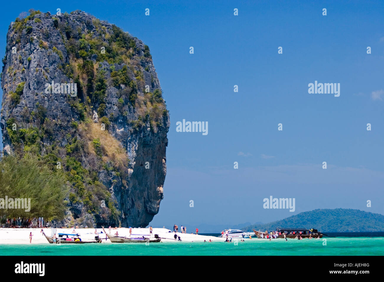 Tall rock towers over white sand of popular Ko Poda island off Ao Nang ...