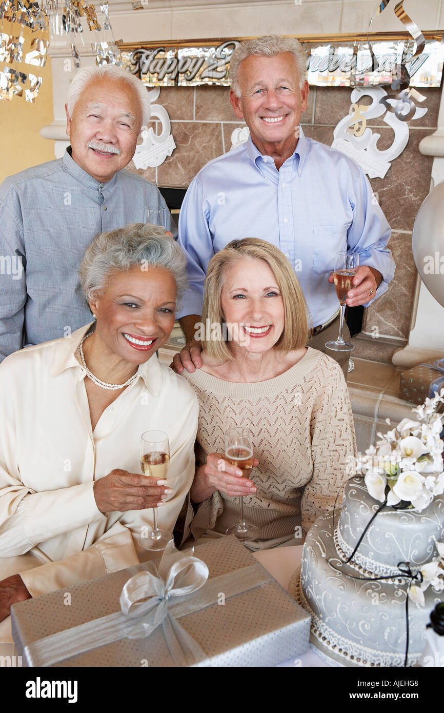 Middle-aged Friends drinking champagne and Celebrating Together Stock ...