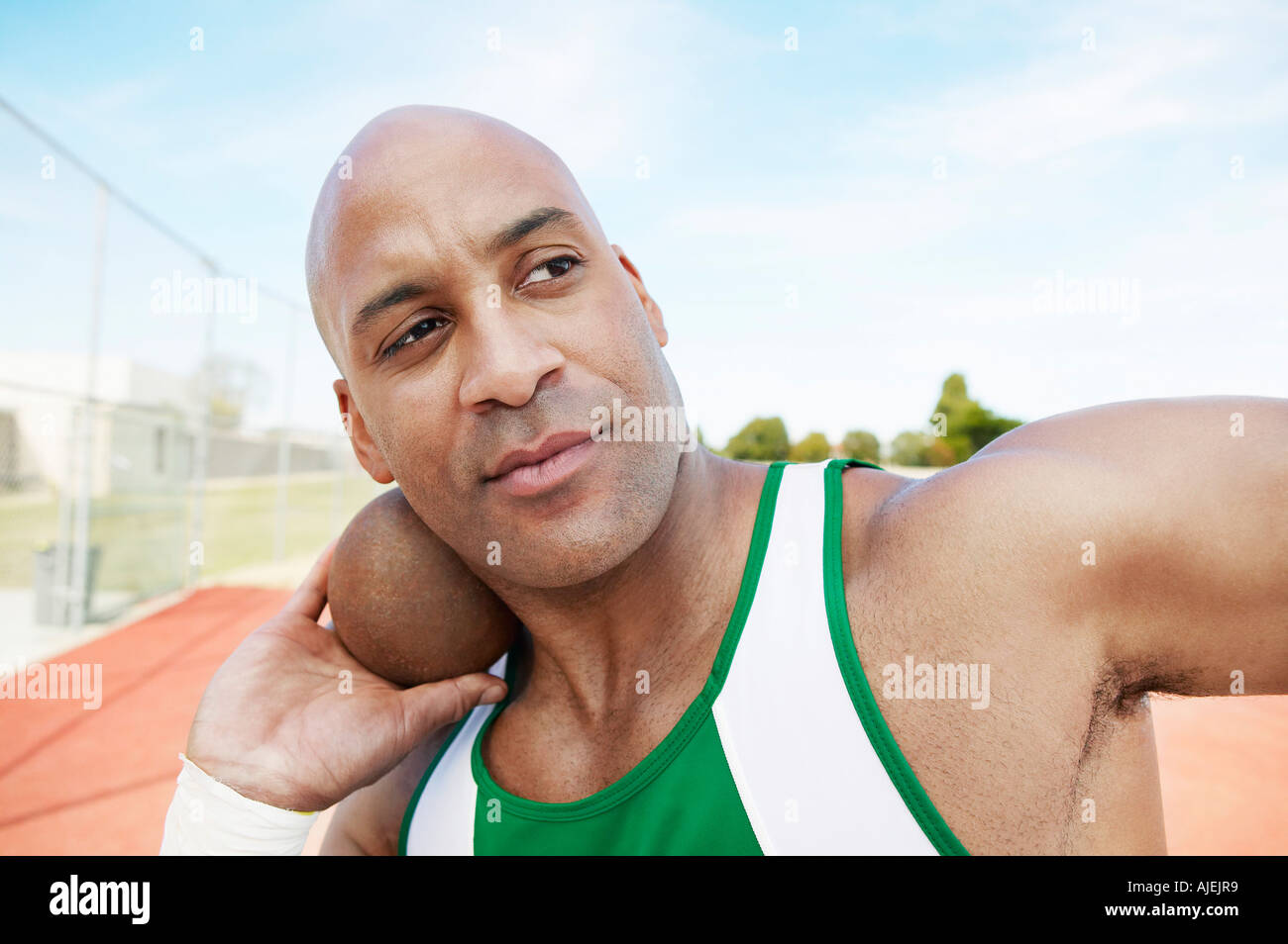 Shot Putter holding shot put, head and shoulders Stock Photo - Alamy