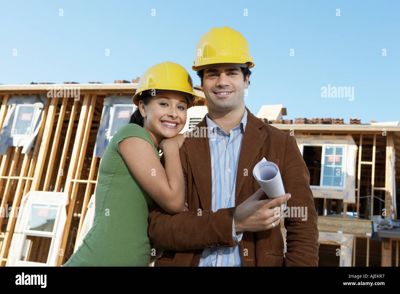 Couple in front of houses being built Stock Photo - Alamy