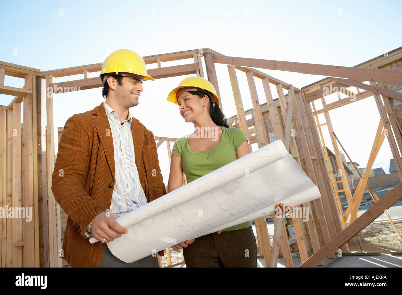 Couple in front of house being built Stock Photo - Alamy