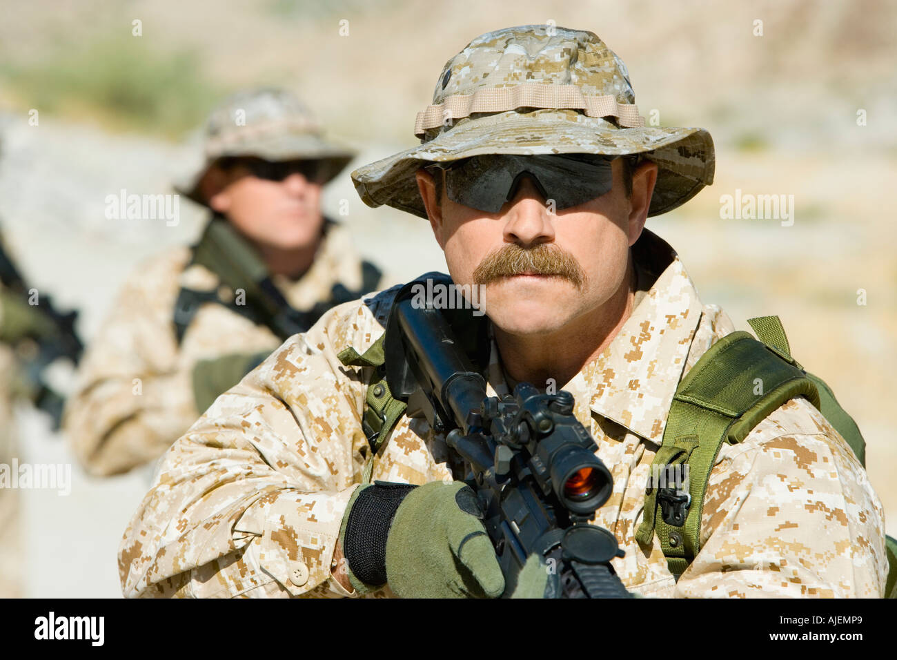 Soldier carrying rifle, outdoors Stock Photo - Alamy