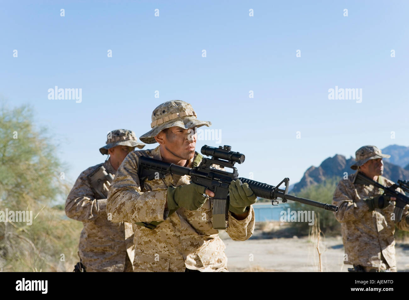 Soldiers carrying rifles in the field Stock Photo - Alamy