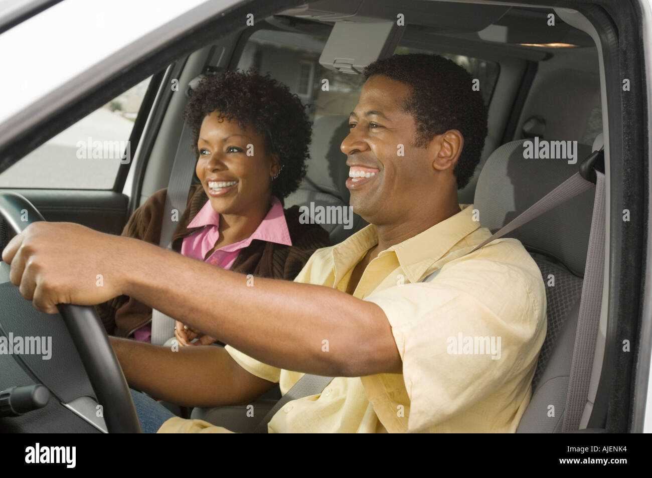 Couple in car, man driving, close-up Stock Photo - Alamy