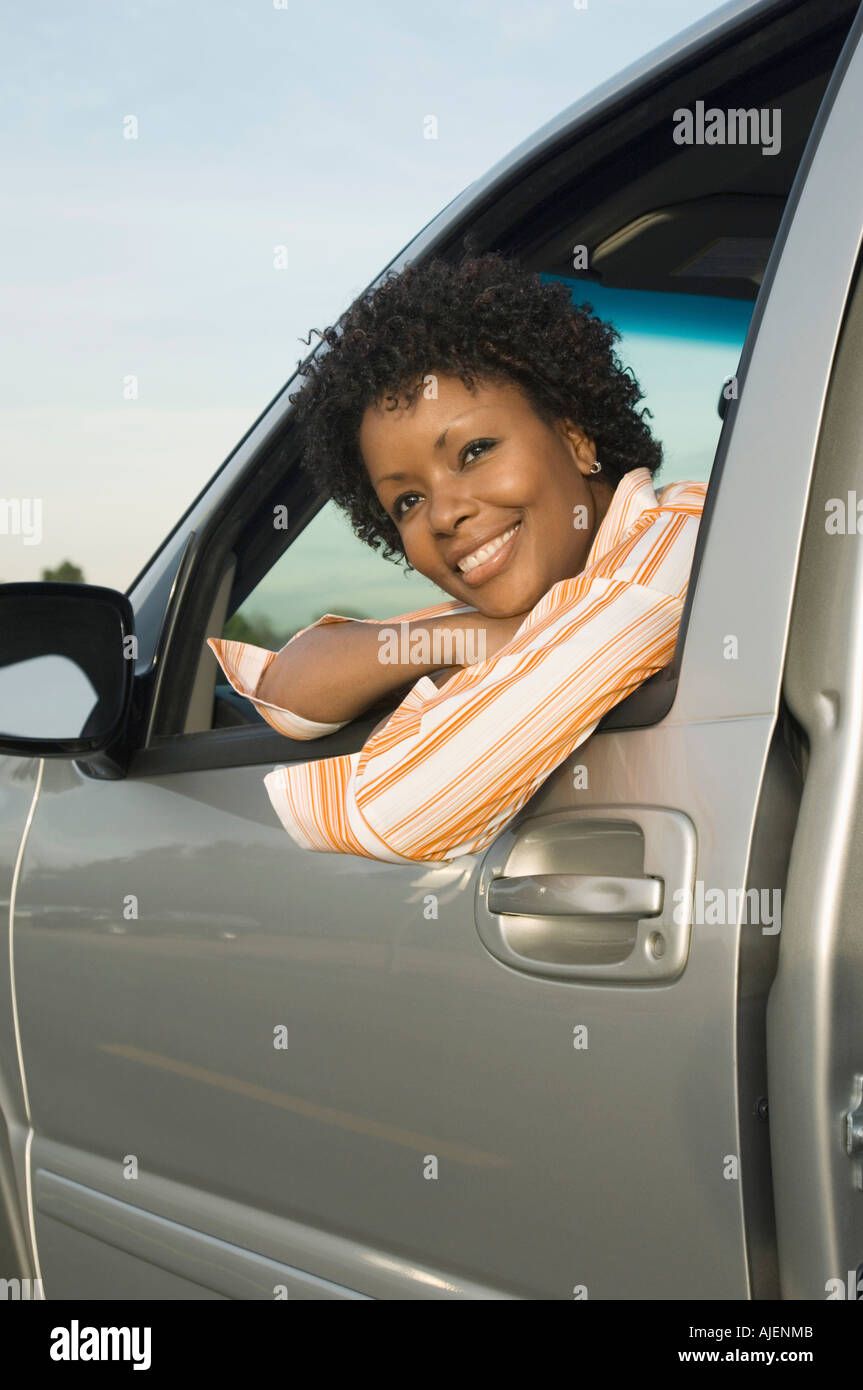 Young woman looking through car window Stock Photo - Alamy
