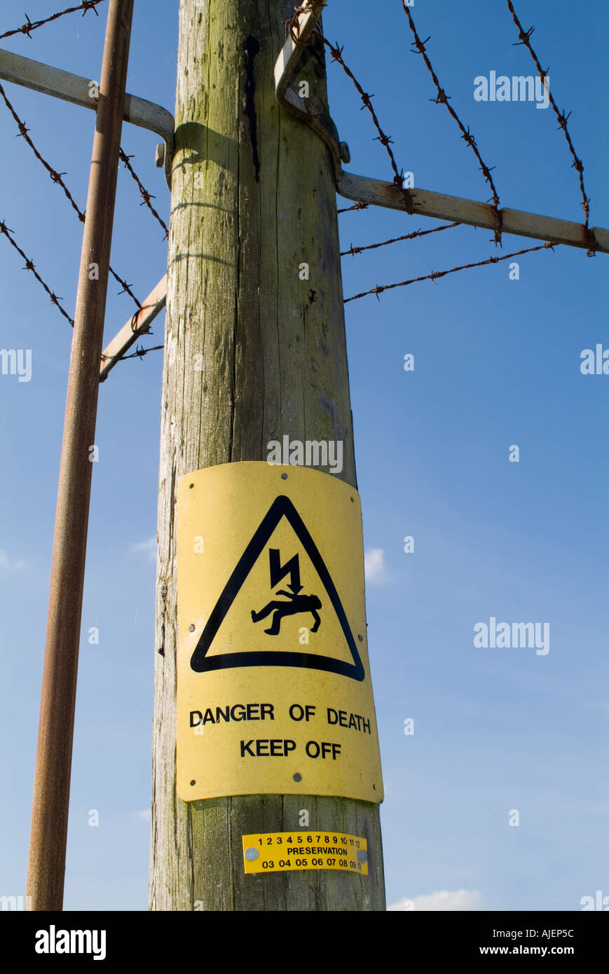 electricity pylon with blue sky and danger of death sign Stock Photo ...