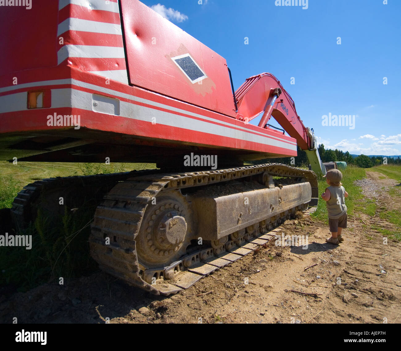 Young boy looking at a red bulldozer Stock Photo - Alamy