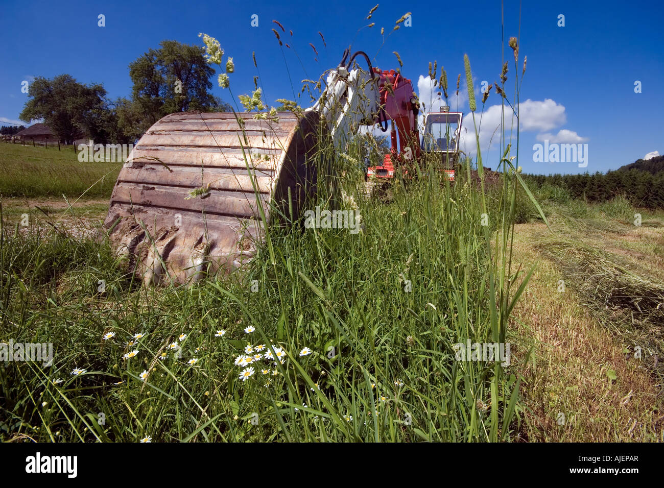 Red digger bulldozer in field Stock Photo - Alamy