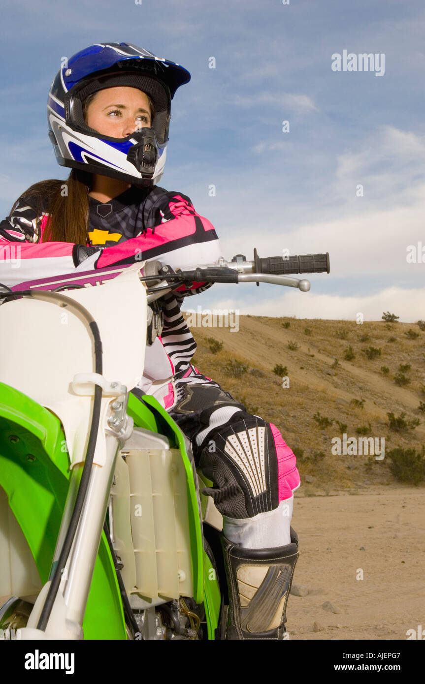 Female motocross racer on bike in desert Stock Photo - Alamy