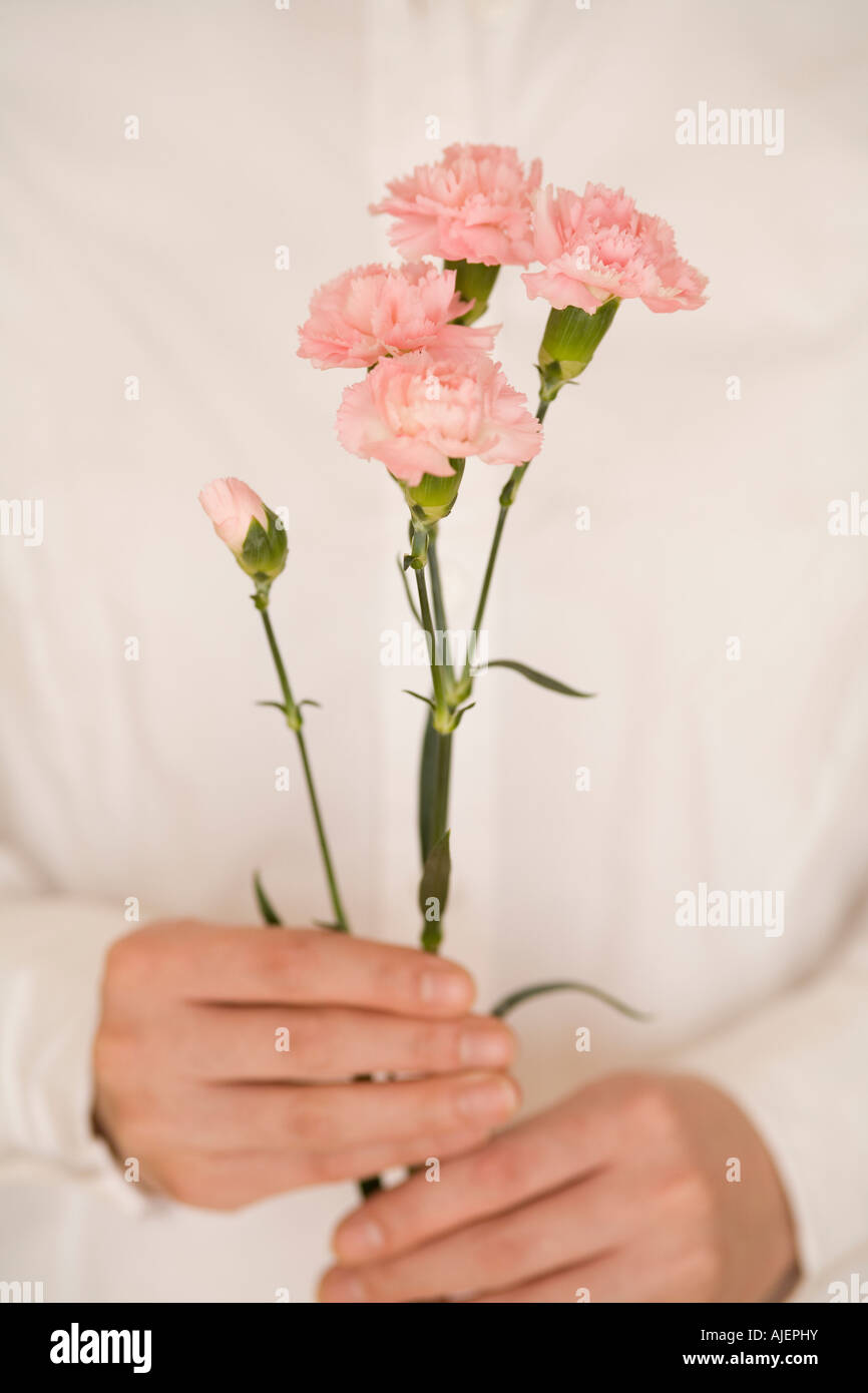 Young woman holding carnation Stock Photo - Alamy