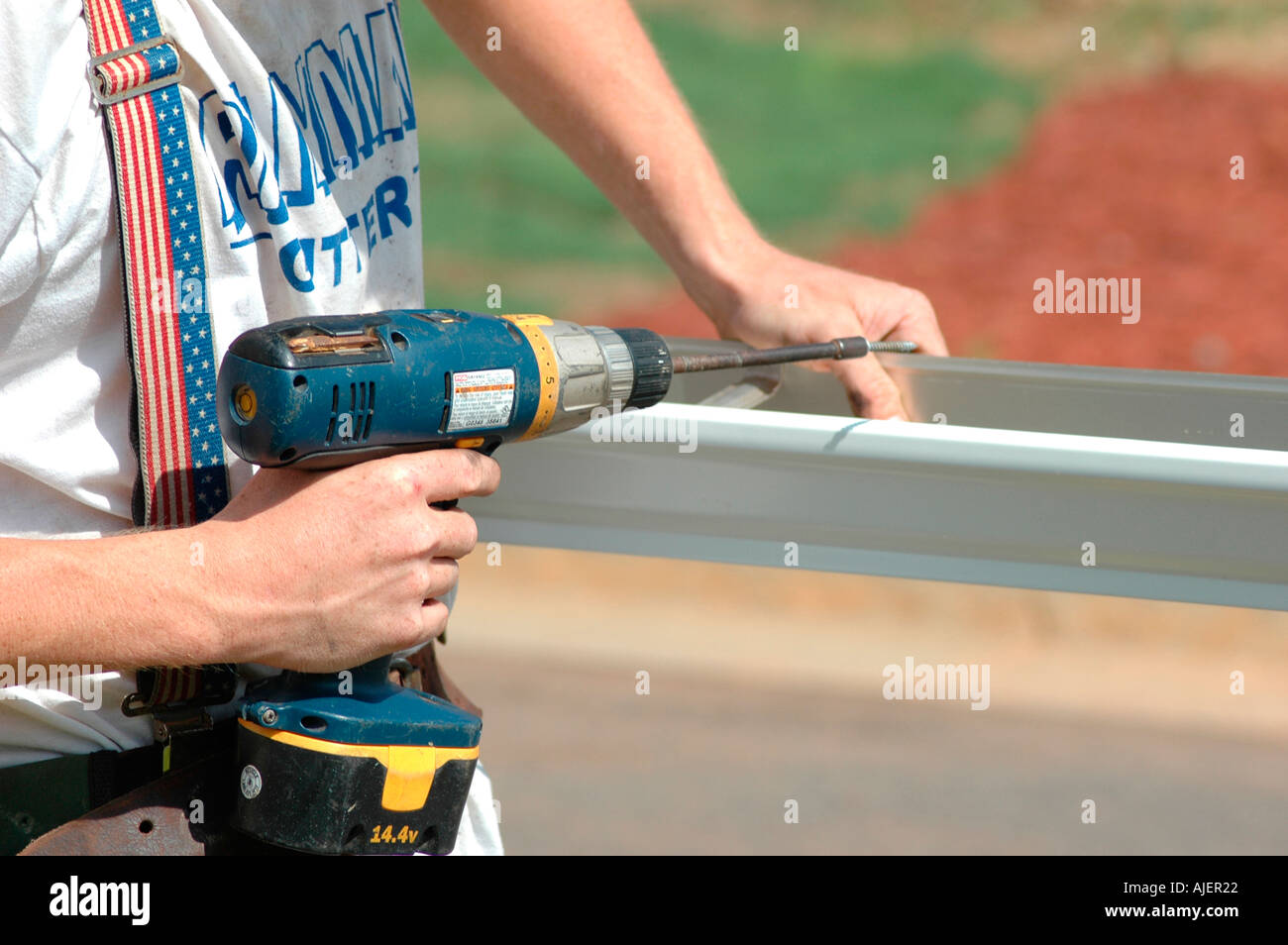 Installation of rain water run off gutters by young men on ladders and ...