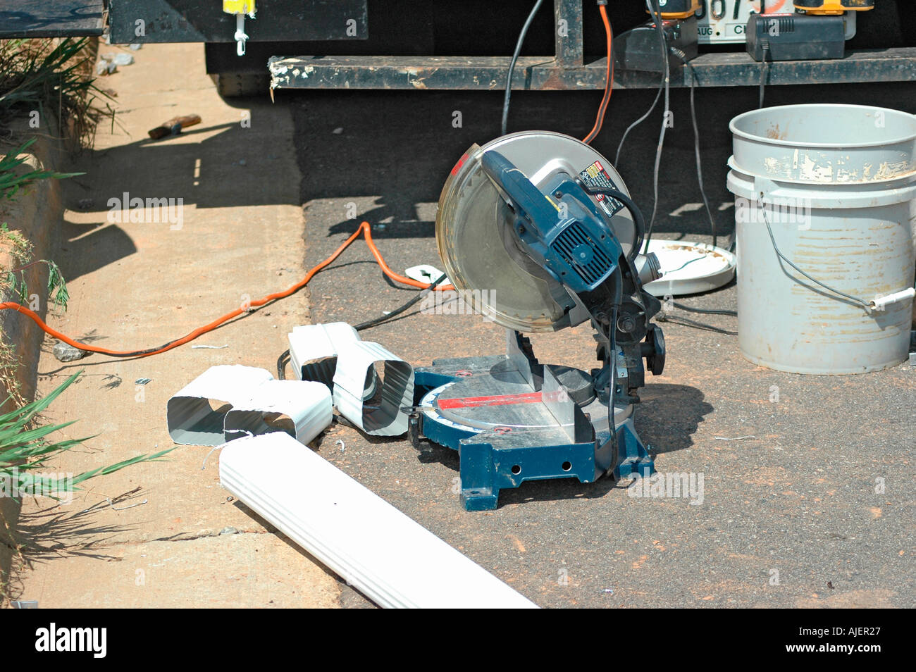 Installation of rain water run off gutters by young men on ladders and ...