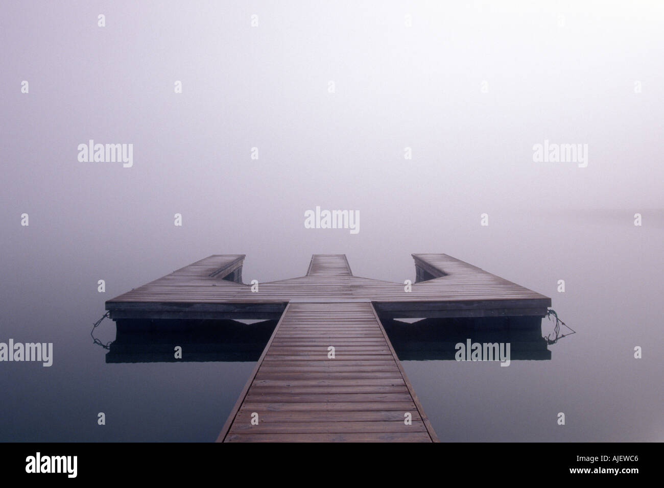 Fishing dock in fog at sunrise Stock Photo - Alamy