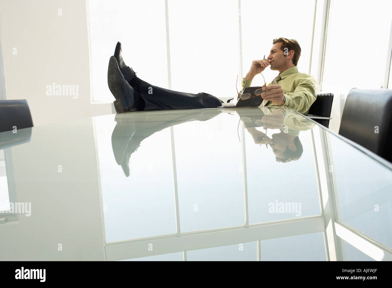Man Sitting With Feet Up On Table High Resolution Stock Photography and ...