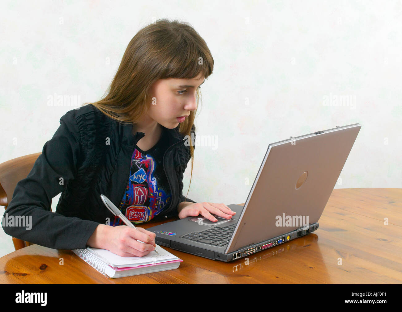 Girl studying on a laptop using the internet Stock Photo - Alamy