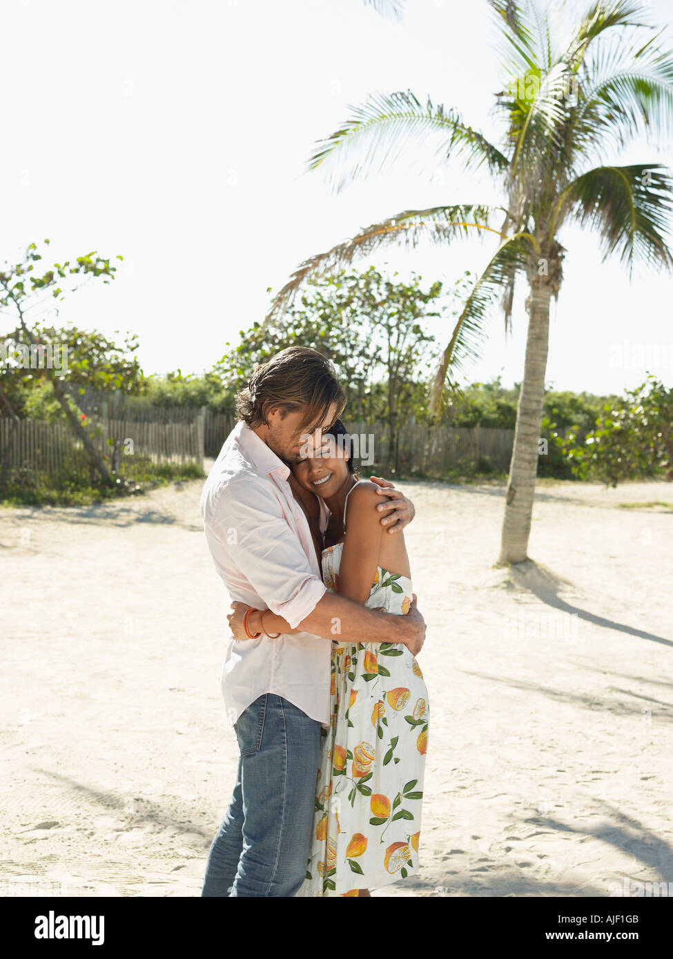 Couple Hugging on Beach Stock Photo - Alamy