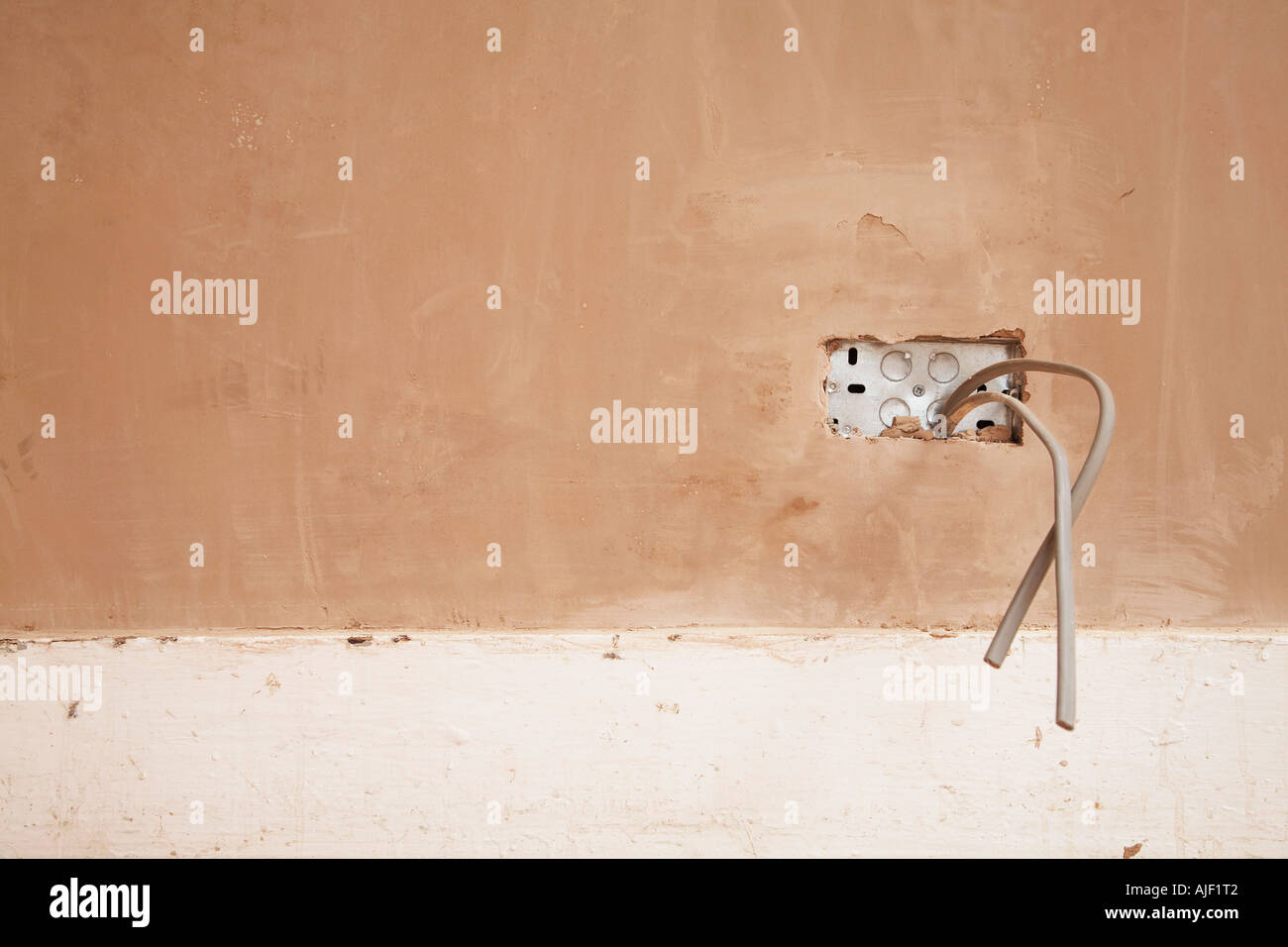 Electrical wires protruding from newly plastered wall Stock Photo - Alamy