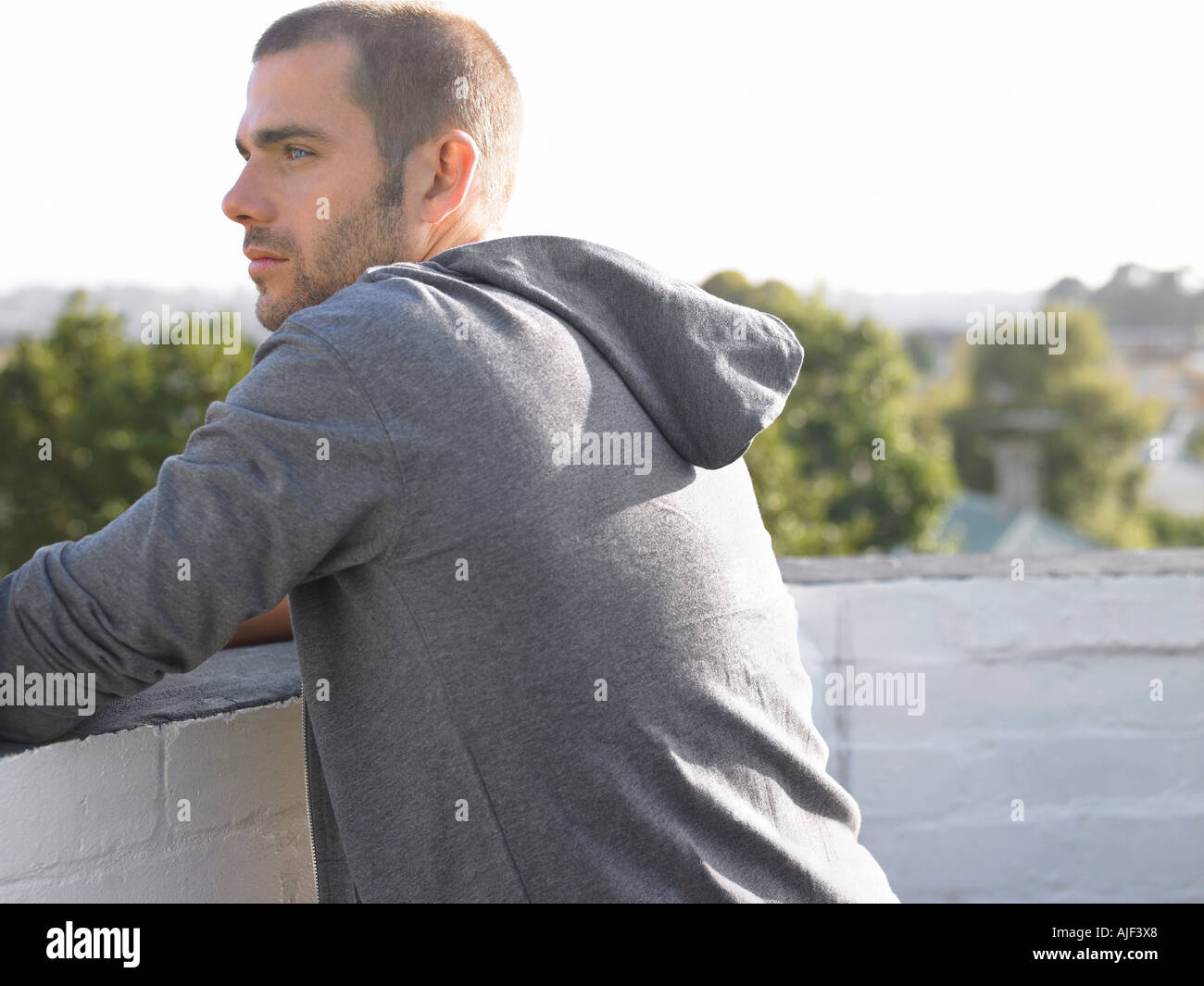 Man looking over balcony hi-res stock photography and images - Alamy