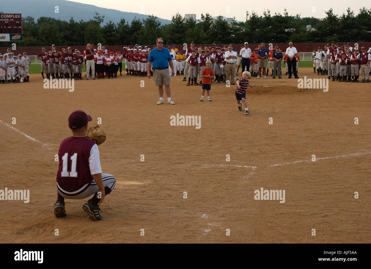 Youth baseball game action Young boy throw the first pitch at a ...