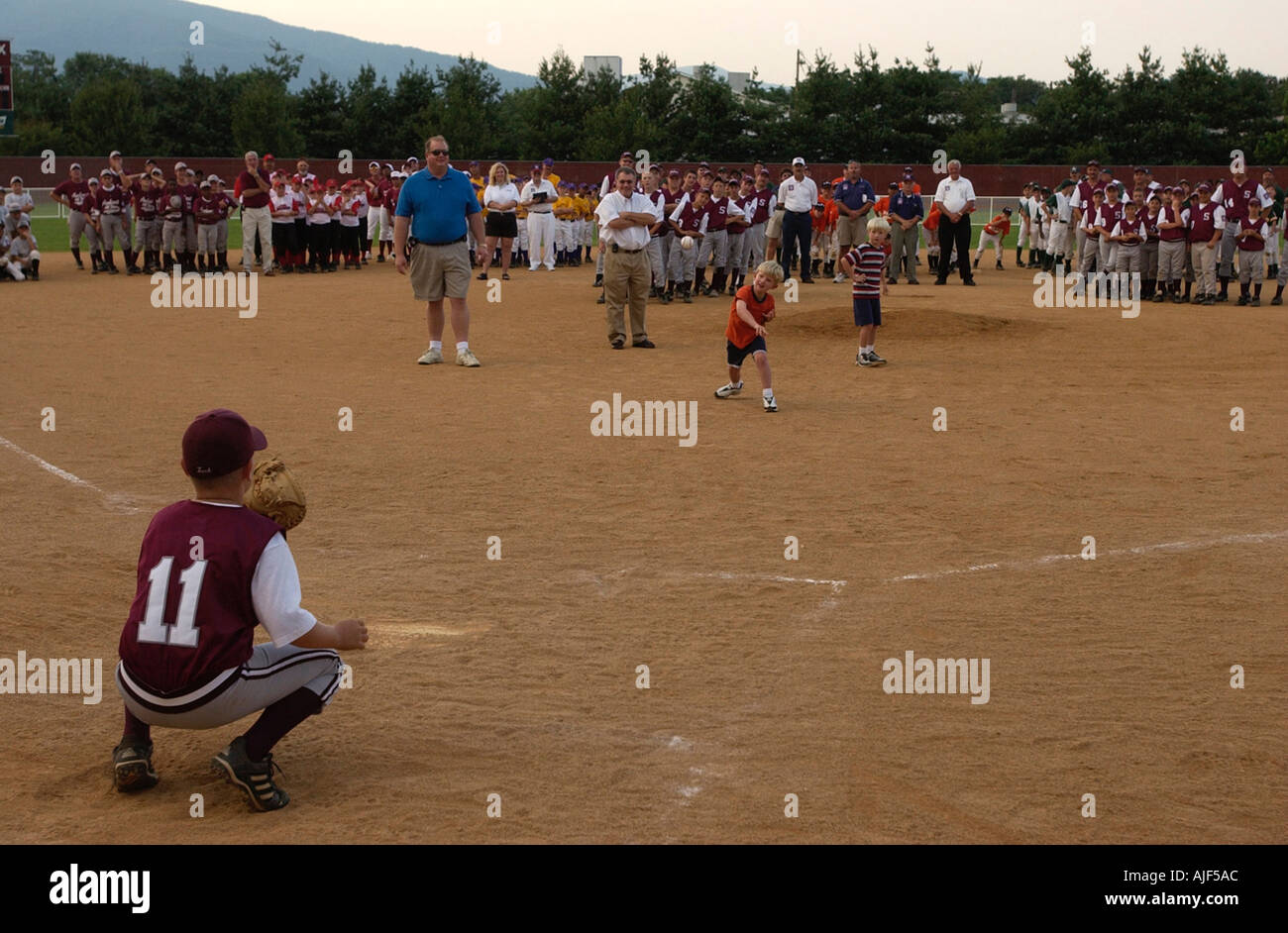 Youth baseball game action Young boy throw the first pitch at a ...
