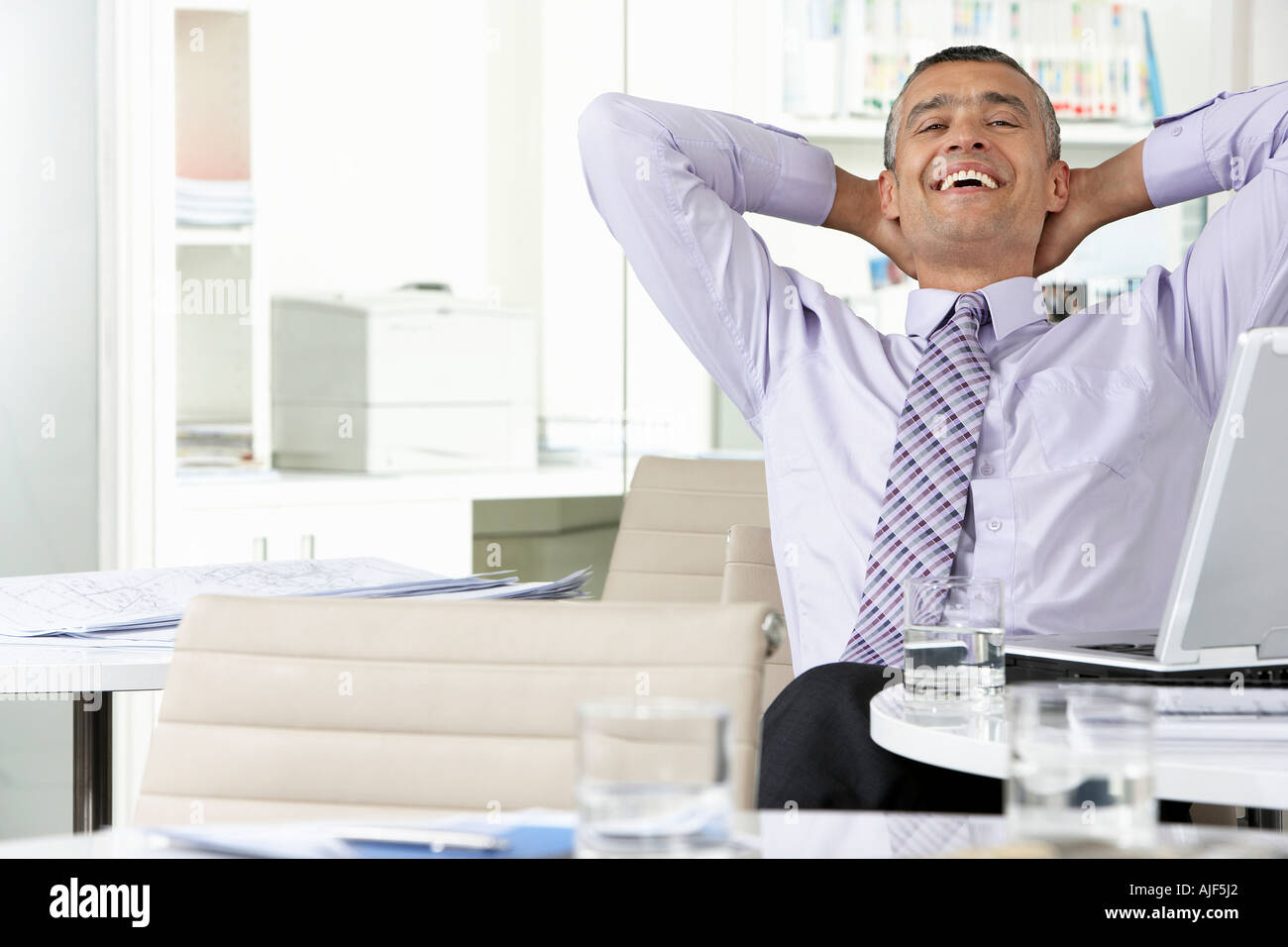 Man desk leaning back hands hi-res stock photography and images - Alamy