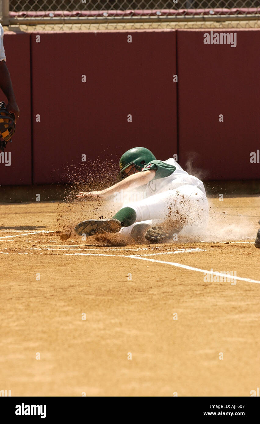 Youth baseball game action Dirt and chalk fly when this runner slides ...