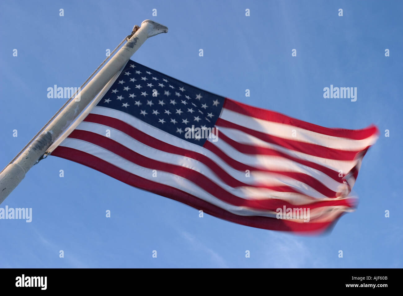 U S flag blowing in wind Stock Photo - Alamy