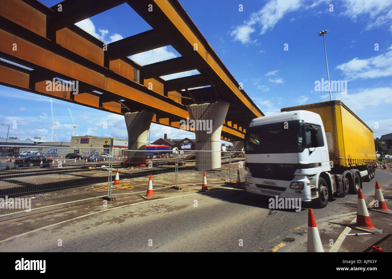 lorry passing underneath construction of flyover road bridge across the ...