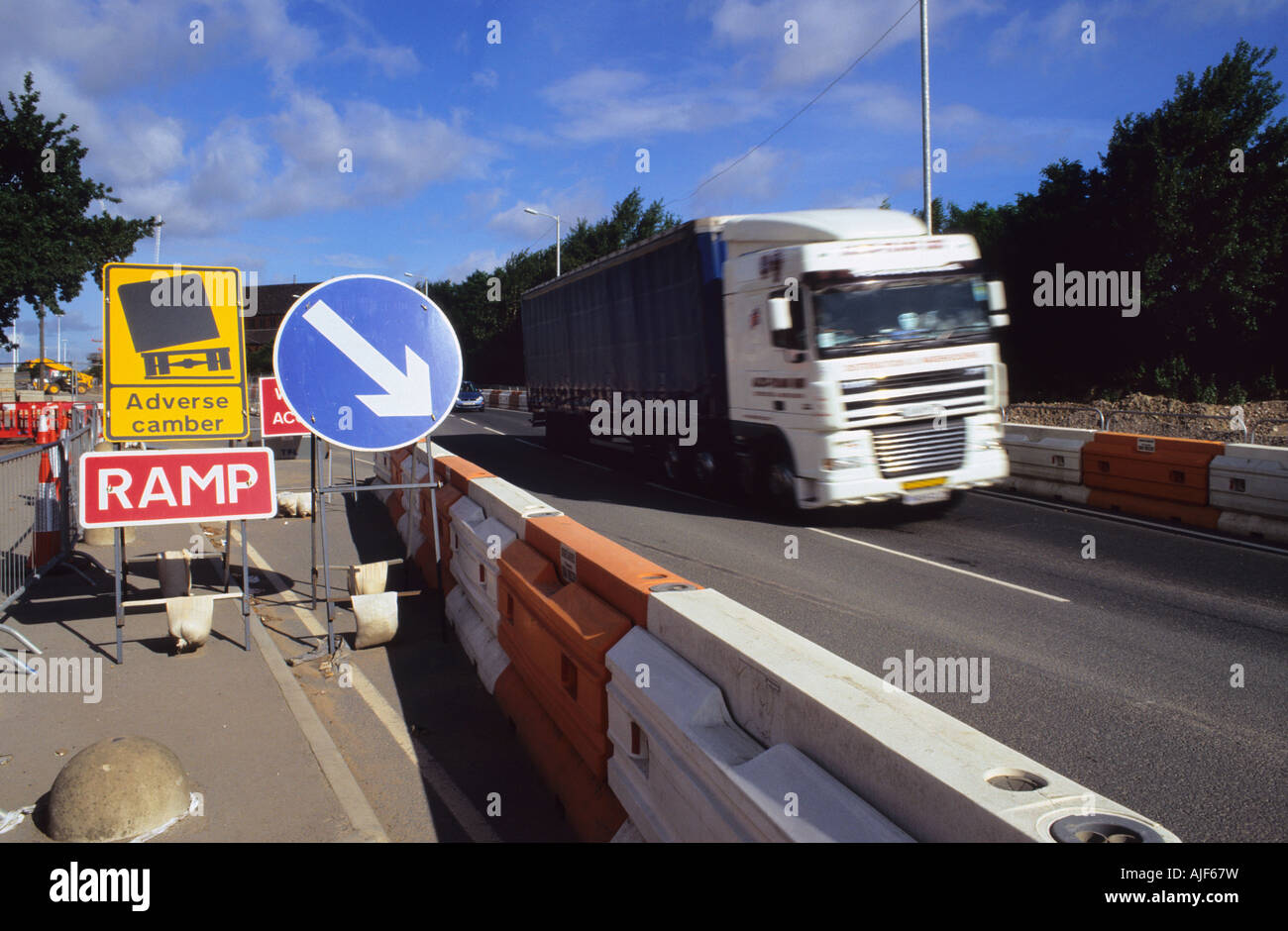 articulated lorry passing warning sign of adverse camber in the road at ...