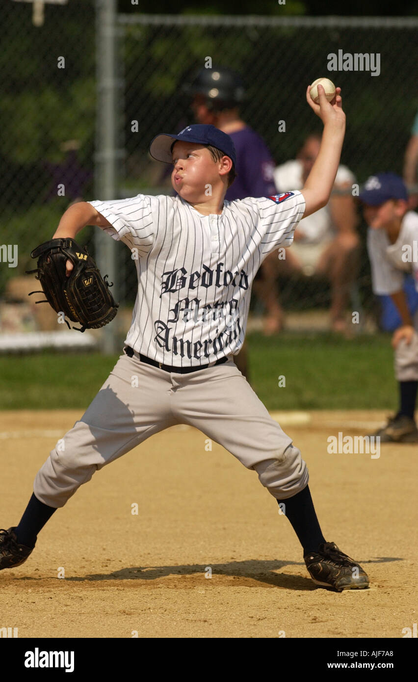Youth baseball pitcher winds up and throws the ball Stock Photo - Alamy