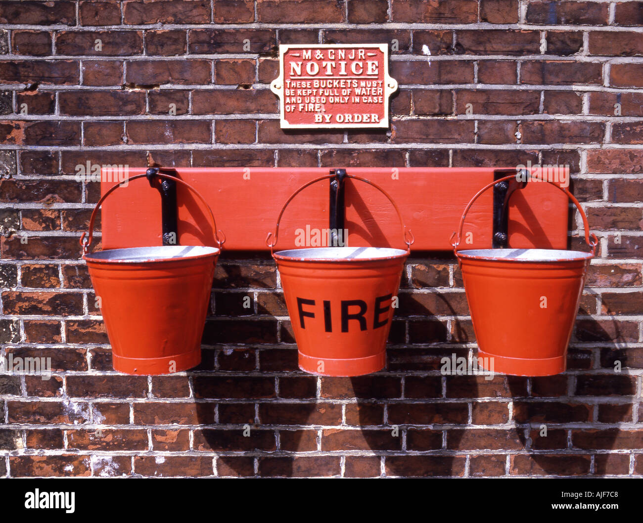 Fire buckets hanging on wall Stock Photo - Alamy