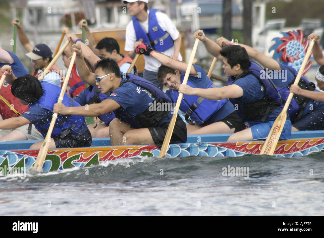dragon boat team working together padding in unison Stock Photo - Alamy