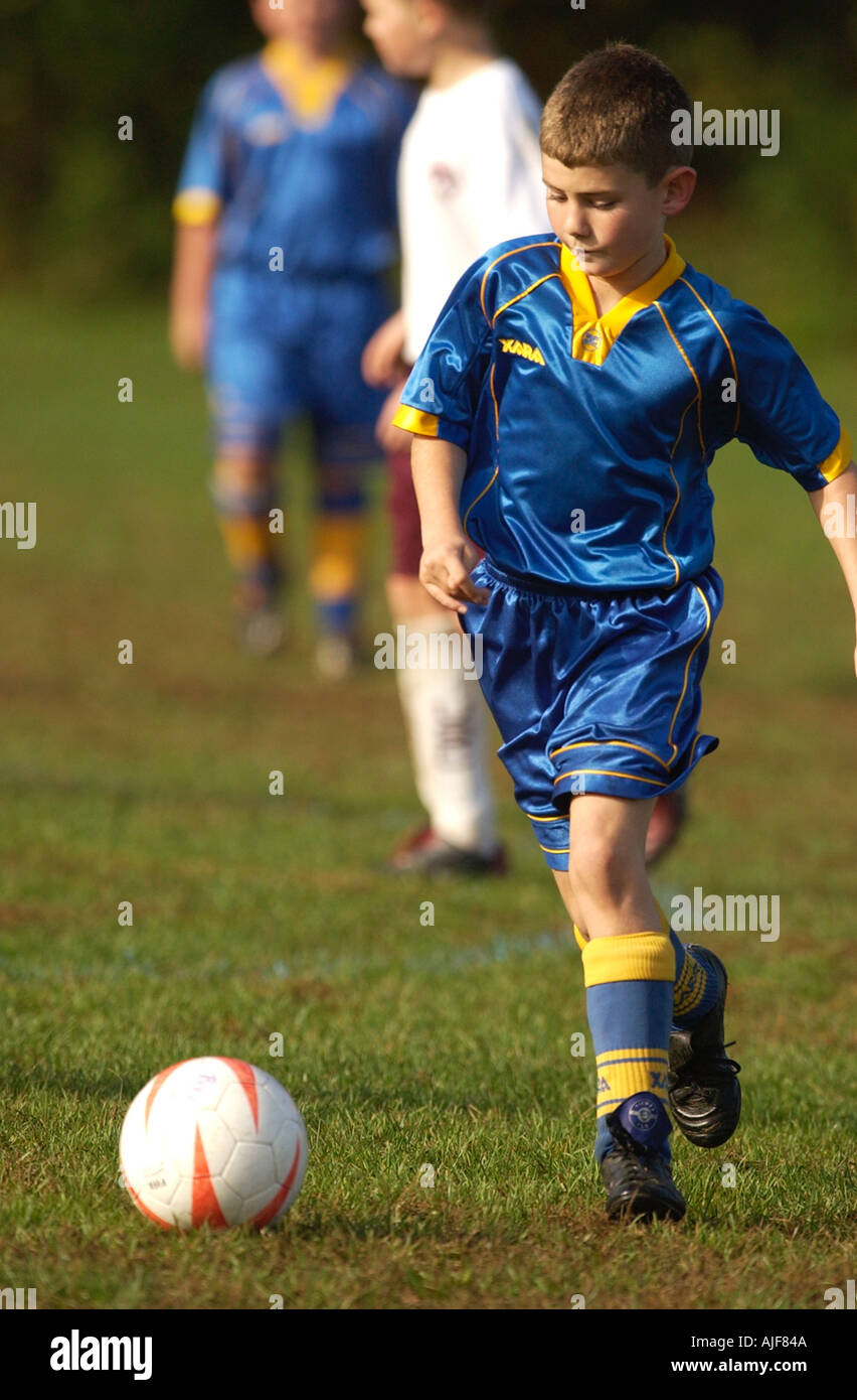 Youth boy s football action American soccer Stock Photo - Alamy