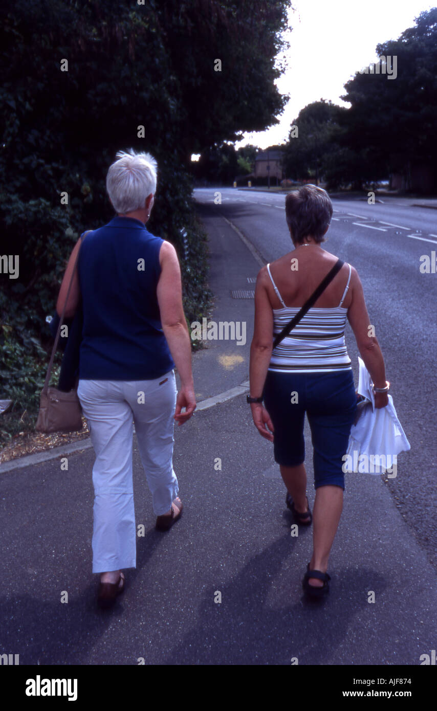 back view two middle aged woman walking together Stock Photo - Alamy