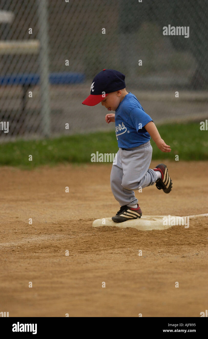 Toddler runs around the bases after a youth baseball game Stock Photo ...