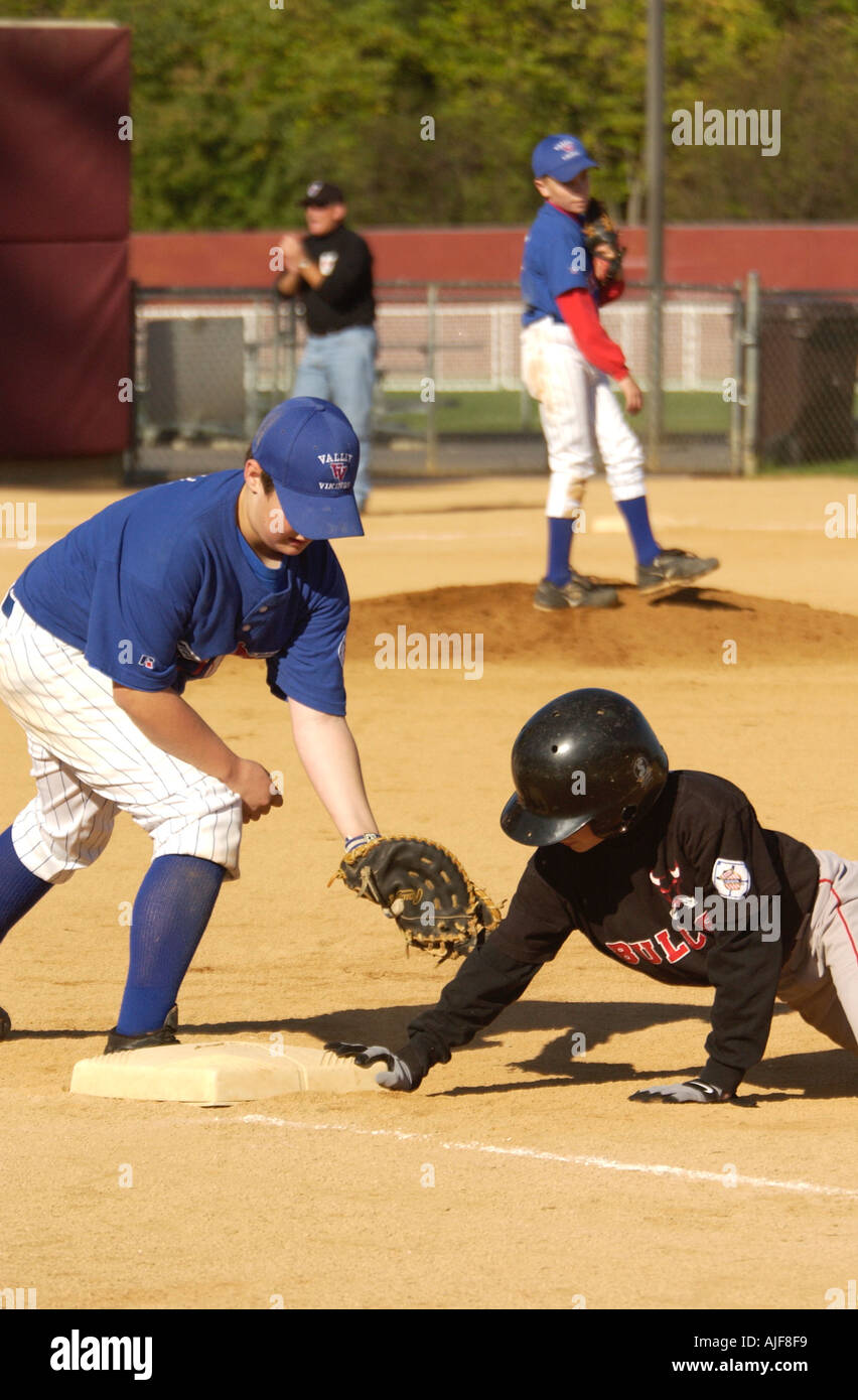 Youth baseball game action Stock Photo - Alamy