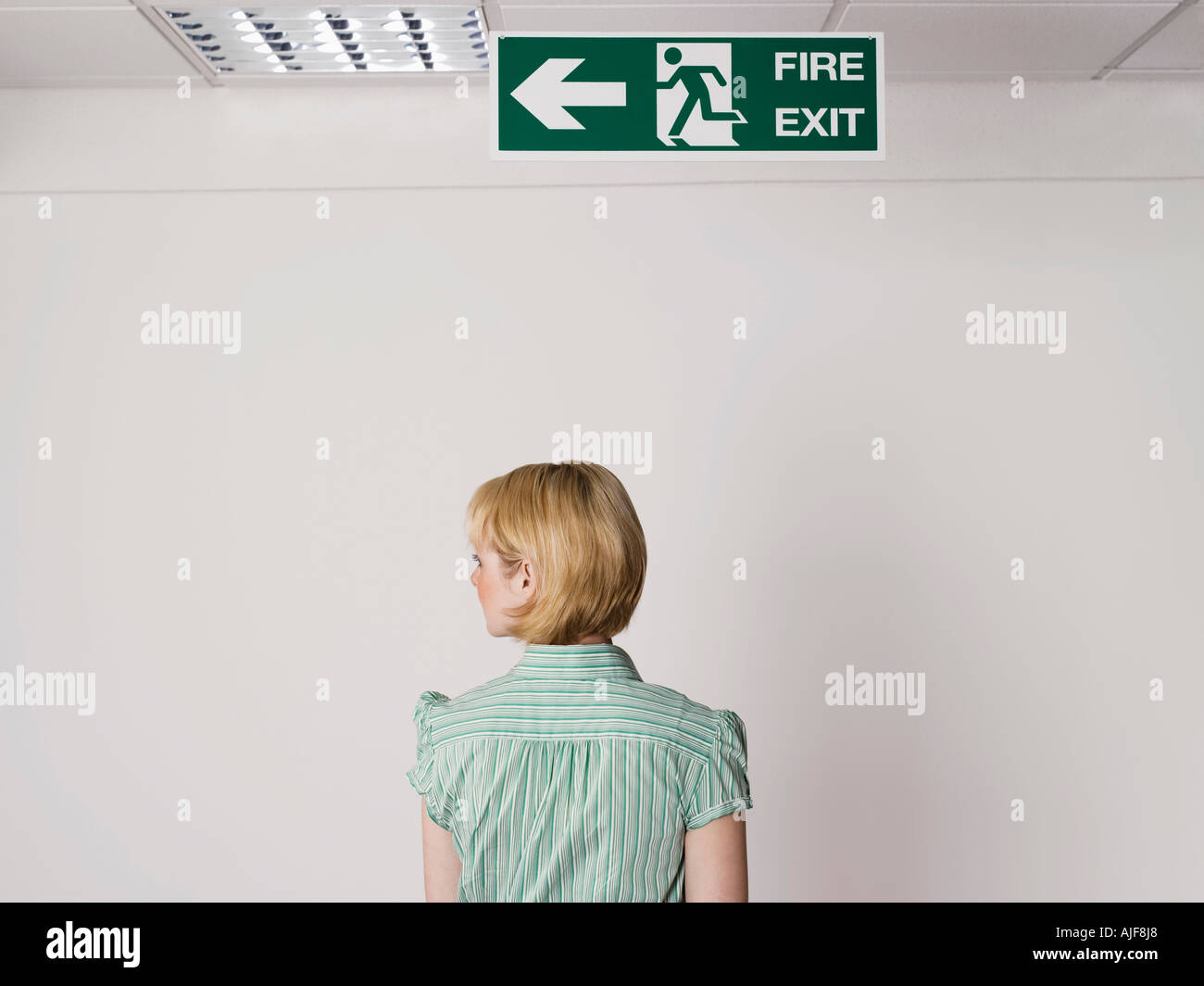 Standing under exit sign hi-res stock photography and images - Alamy