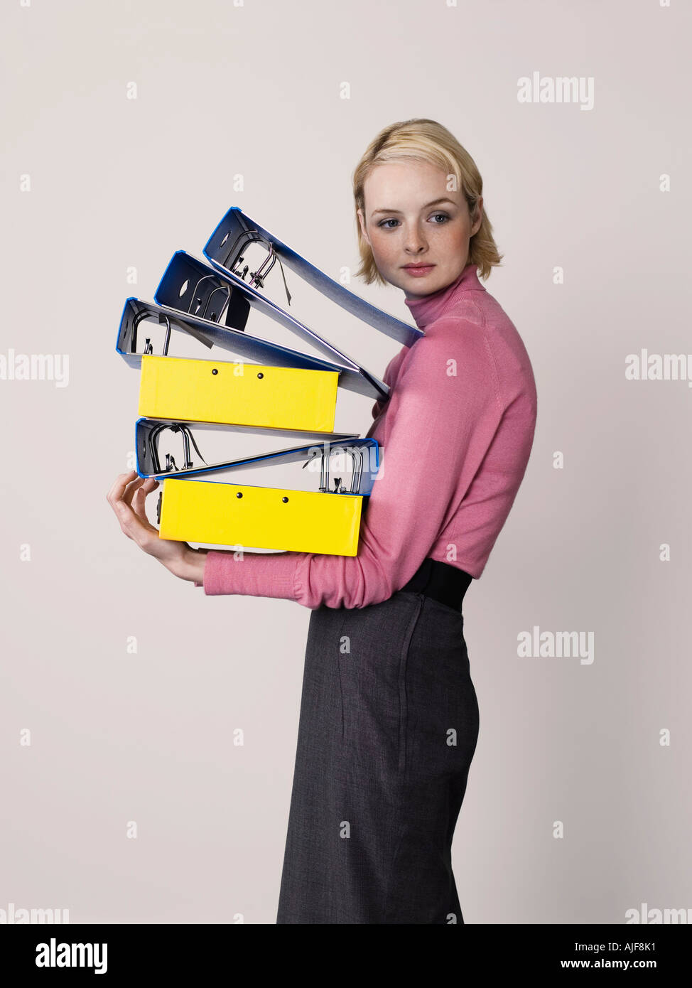 Female office worker carrying empty binders, on white background Stock ...