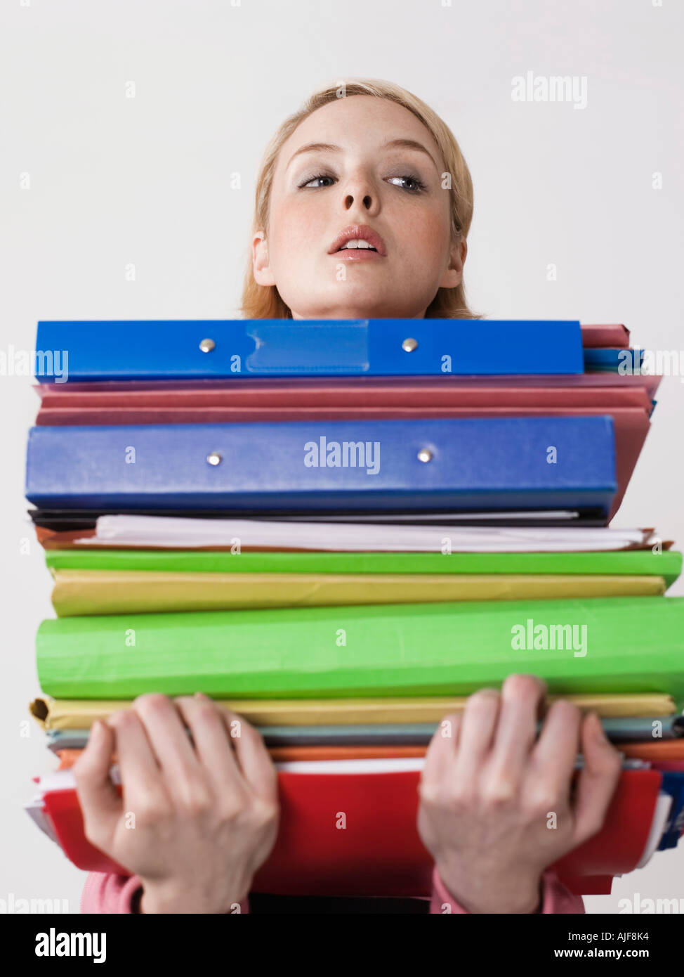 Female office worker carrying heavy binders, close-up Stock Photo - Alamy