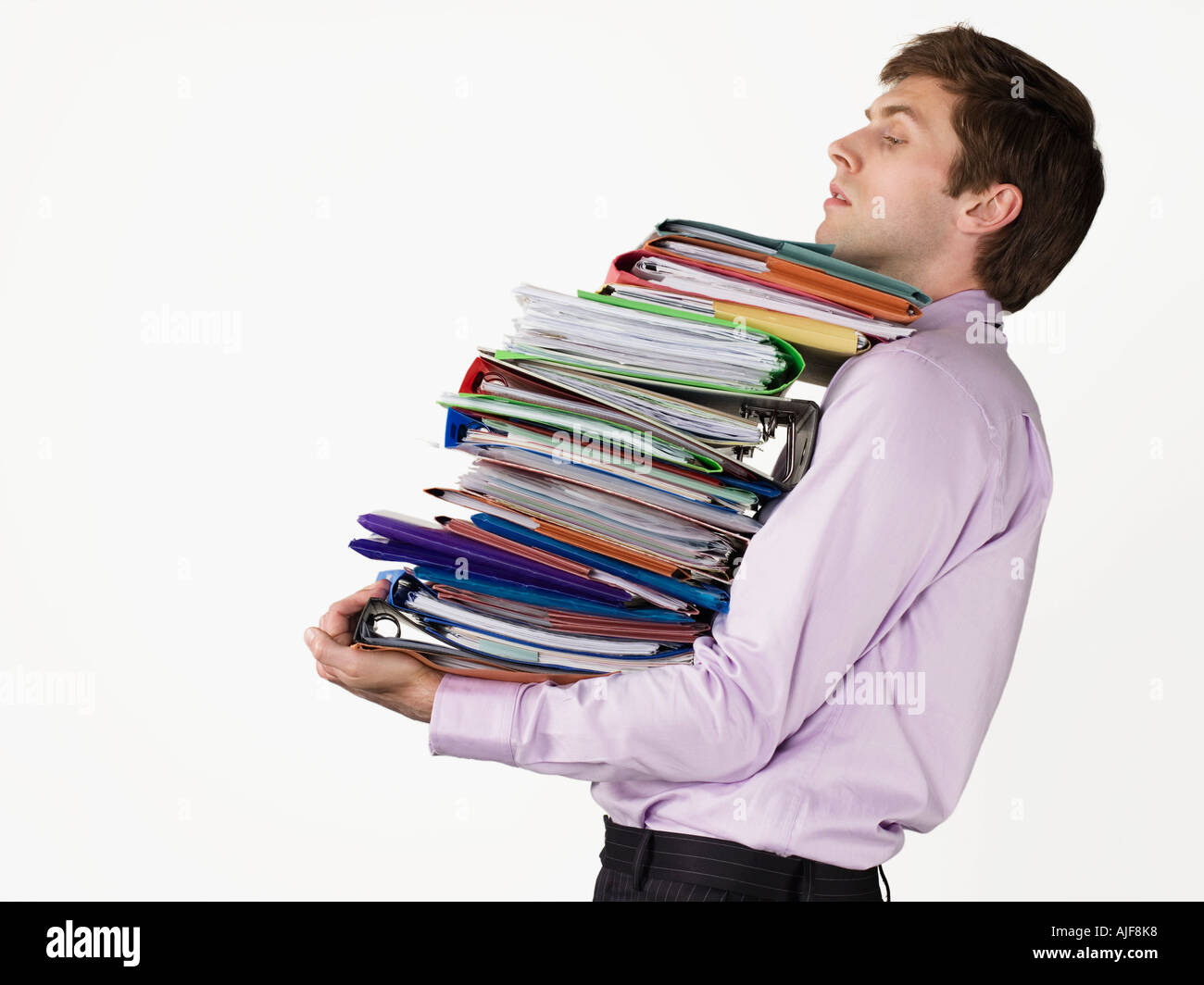 Male office worker carrying heavy binders, on white background Stock ...